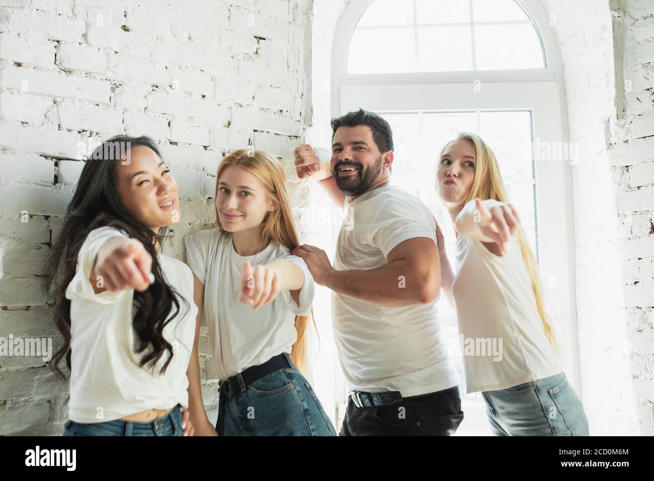 Stylish posing. Group of adorable multiethnic friends having fun at ...