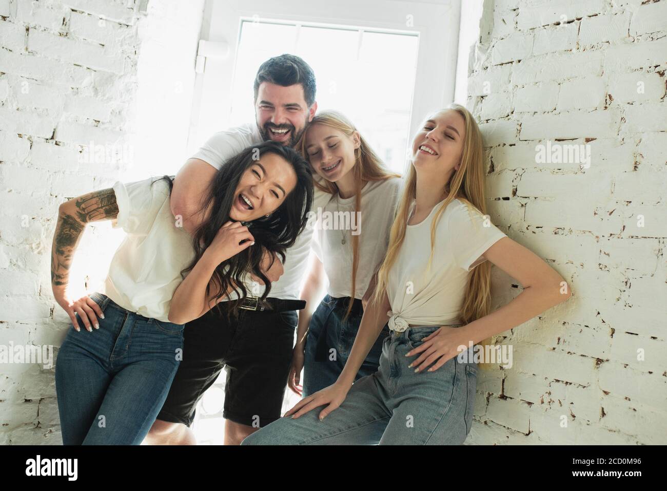 Stylish posing. Group of adorable multiethnic friends having fun at ...