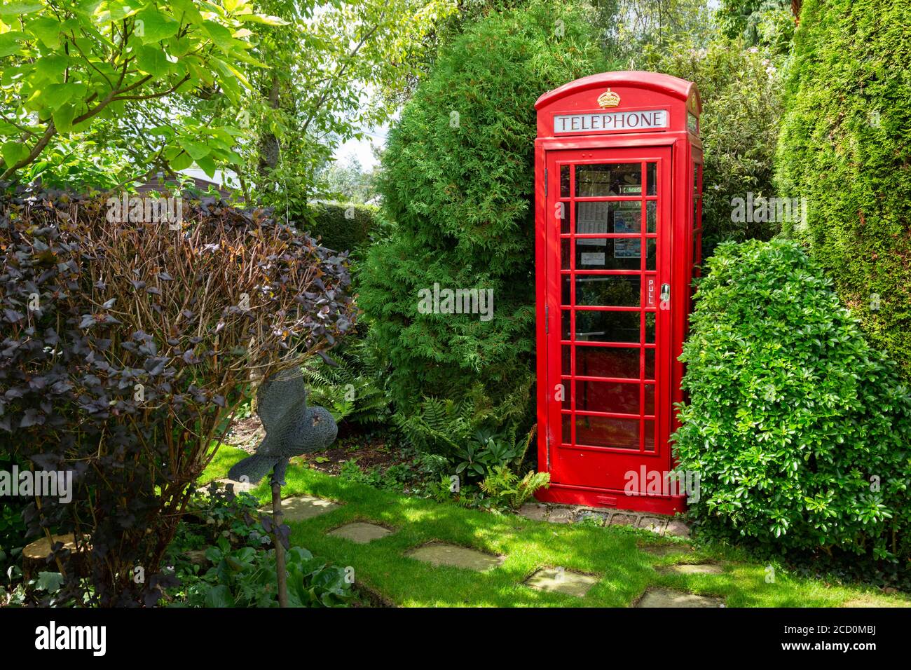 Red telephone box in a garden, UK Stock Photo - Alamy