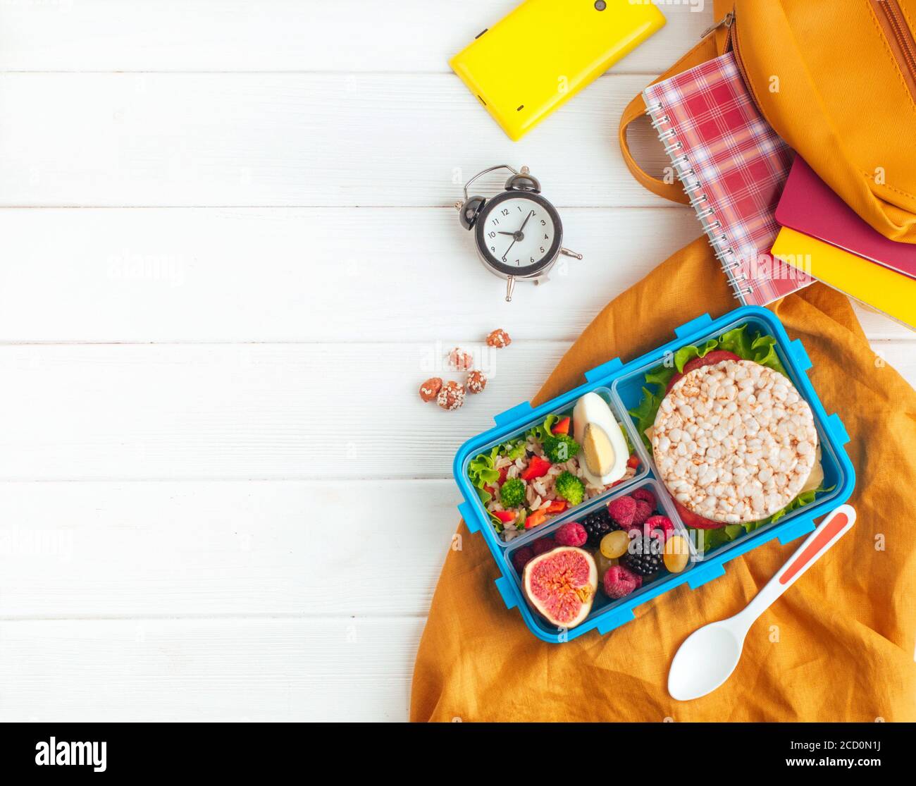 Open lunch box with sandwich, vegetables, egg, fresh berries on the ...