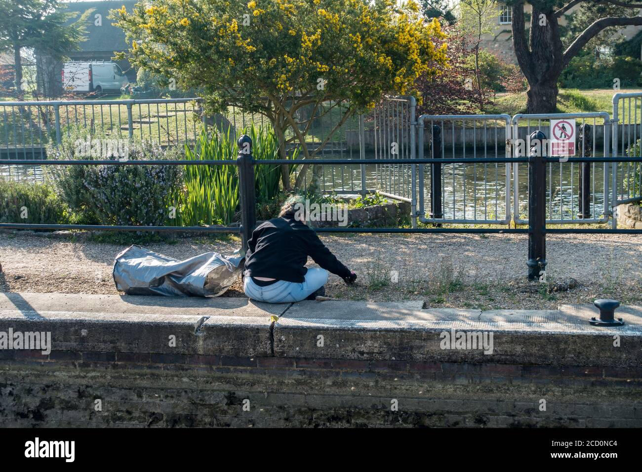 Woman weeding edge of path Baits Bite Lock 2020 Stock Photo - Alamy