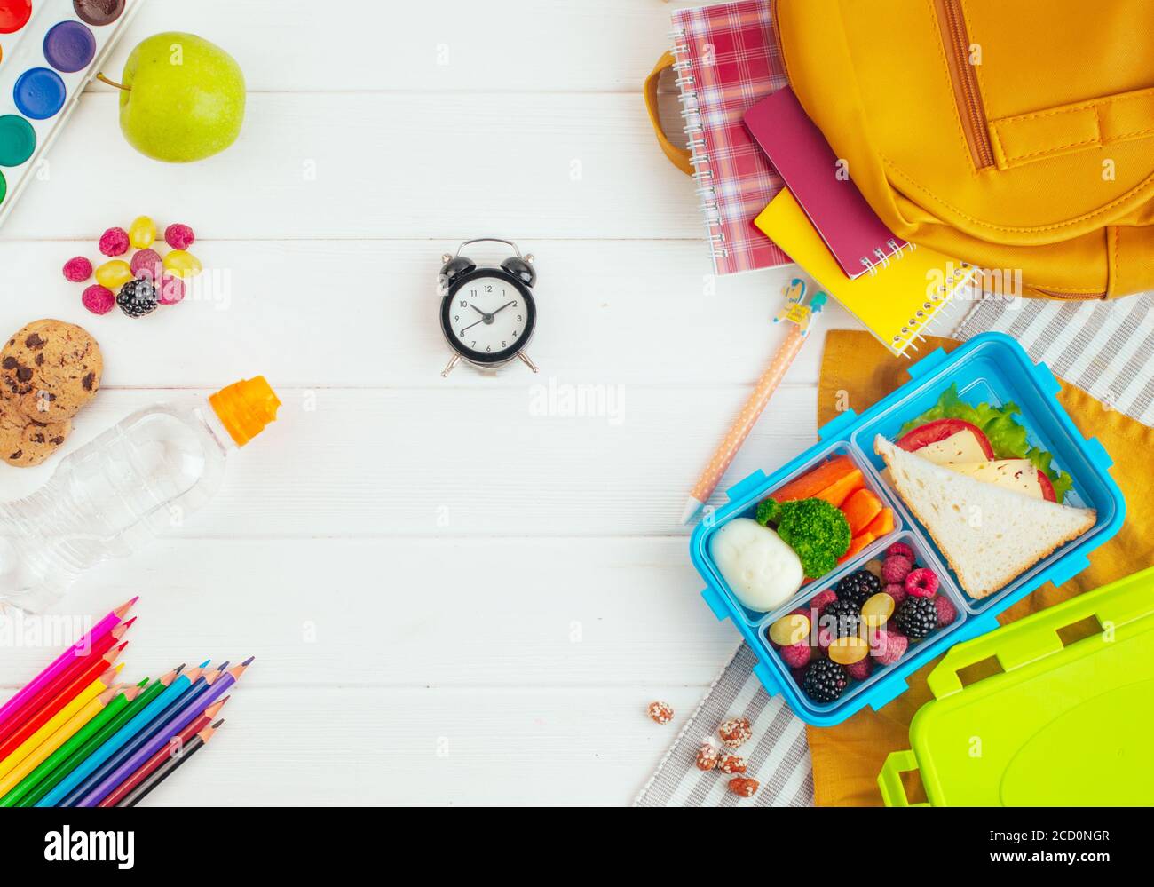 Open lunch box with sandwich, vegetables, egg, fresh berries on the ...