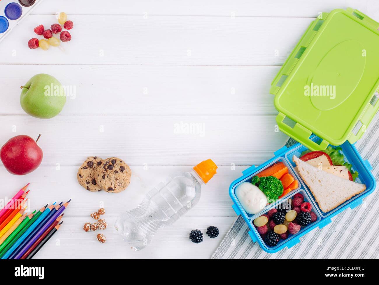 Open lunch box with sandwich, vegetables, egg, fresh berries on the ...