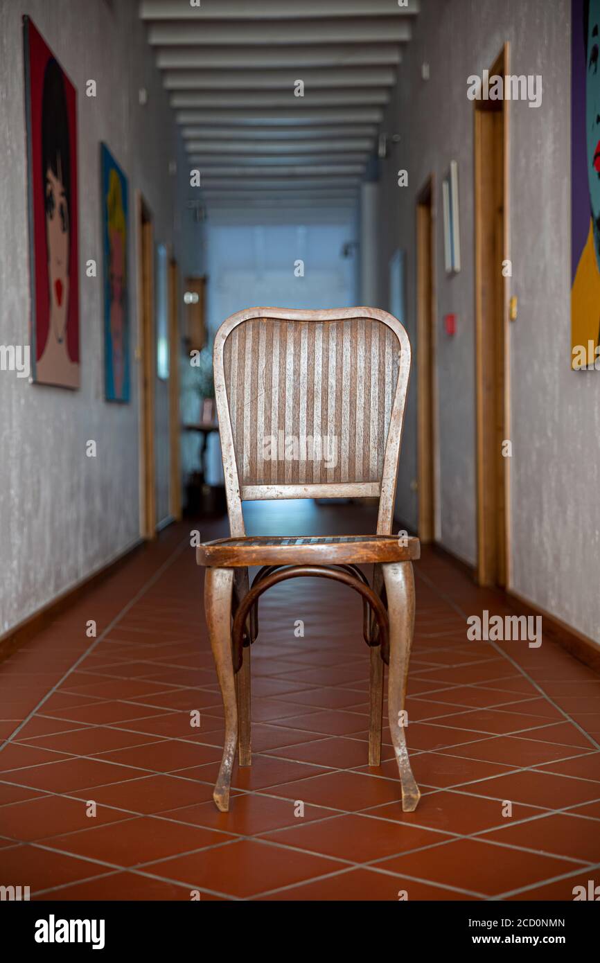 Old wooden vintage classical chair placed in a dark hallway Stock Photo ...
