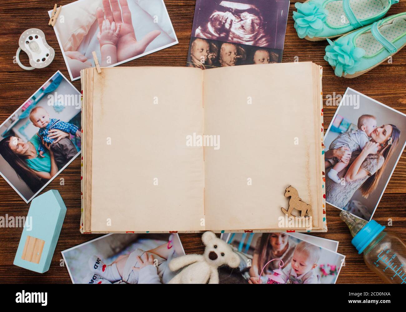 Open vintage album near mother and baby pictures, accessories and ...
