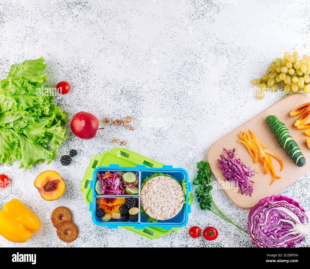 Open lunch box with sandwich, crispbreads, fruits and vegetables with ...