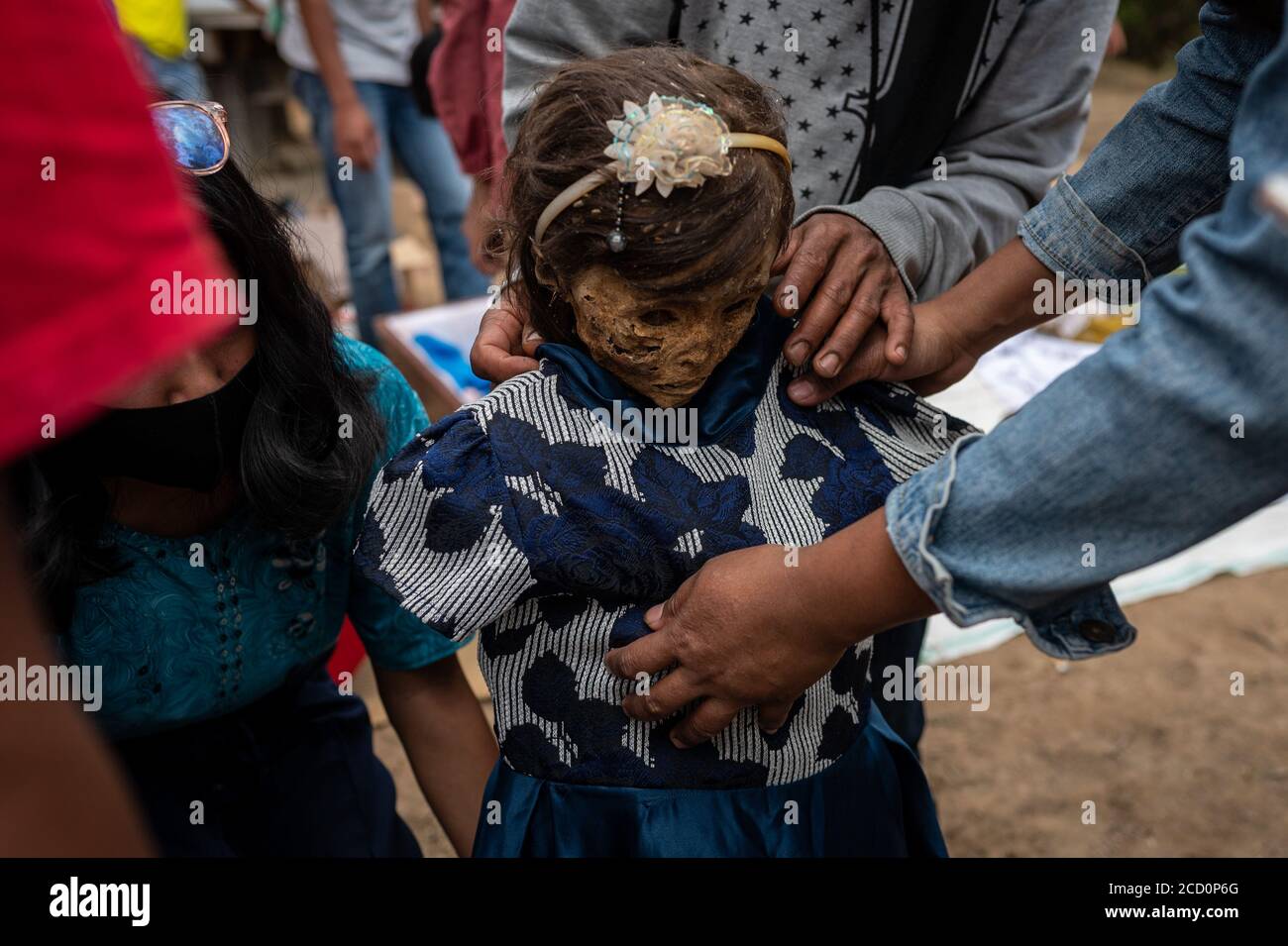 (EDITOR’S NOTE: Image depicts death)Family members dressing the ...