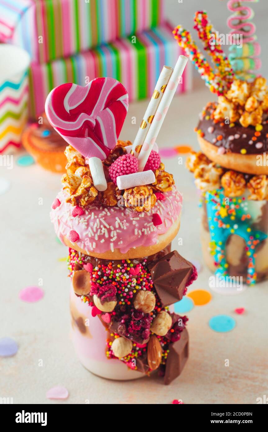 Top view of raspberry freak shake topping with donut, caramel popcorn ...