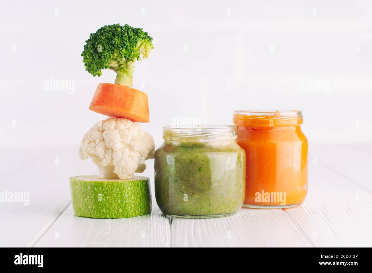 Natural baby food concept. Vegetable puree in two jars near pyramid of ...