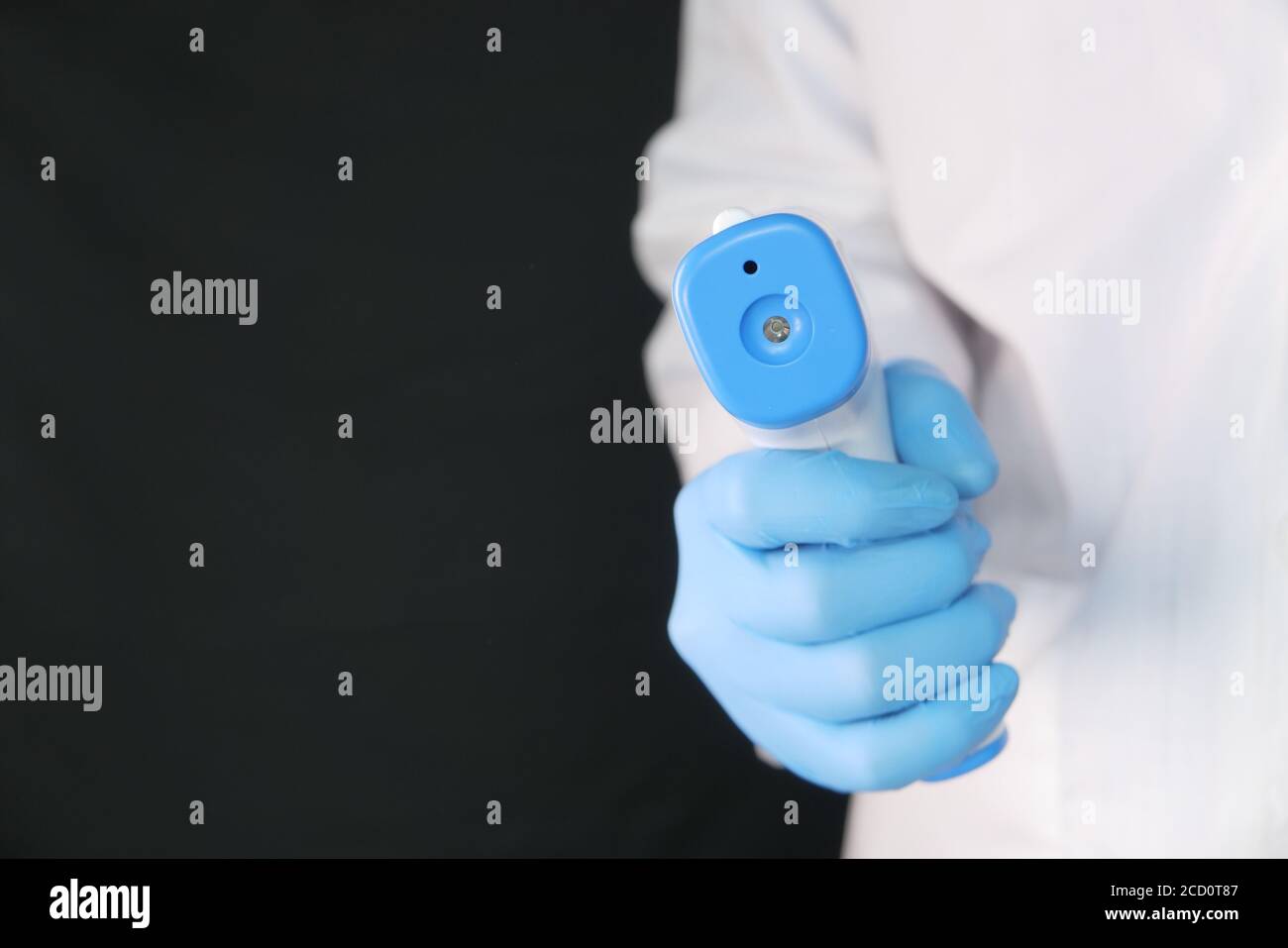 Hand holding infrared thermometer to measuring temperature Stock Photo ...