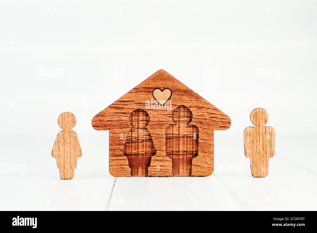 Family home concept. Wooden house with figures of man and woman on ...