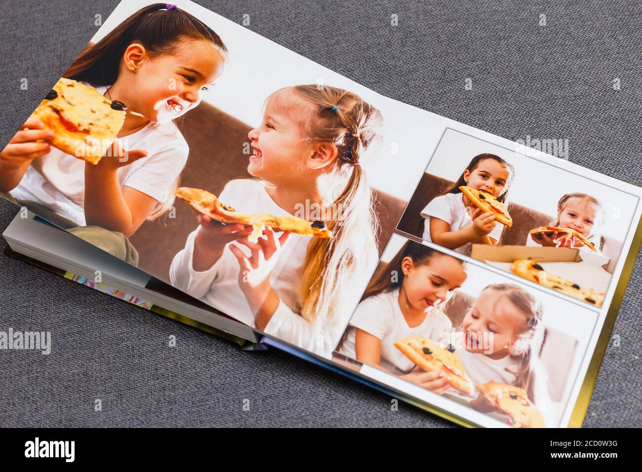 children's photo book, children eat pizza Stock Photo - Alamy