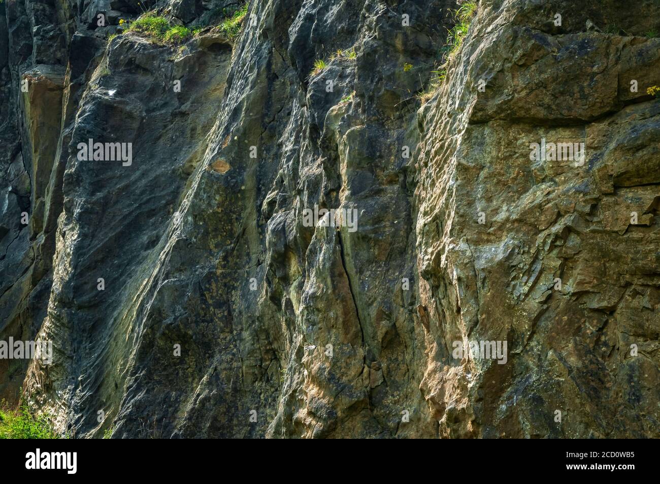 Sunshine playing on the face of a natural cave system truncated by ...