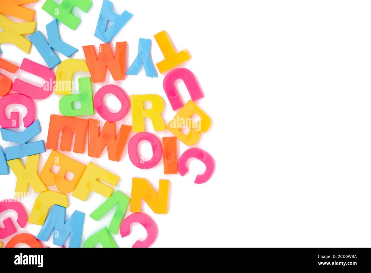 Colored plastic letters of the English alphabet on a white background ...