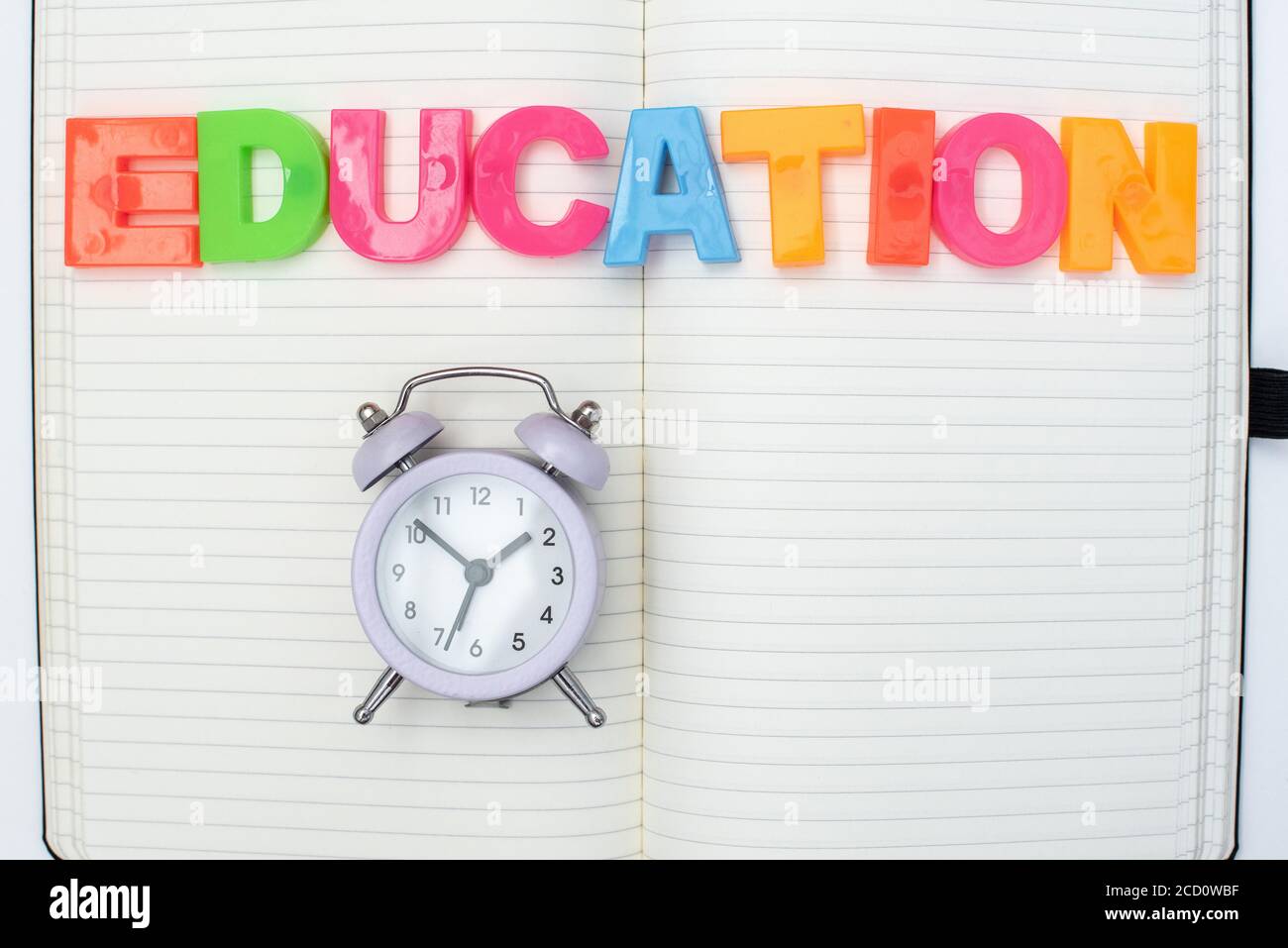 Colored plastic letters of the English alphabet, alarm clock and a ...