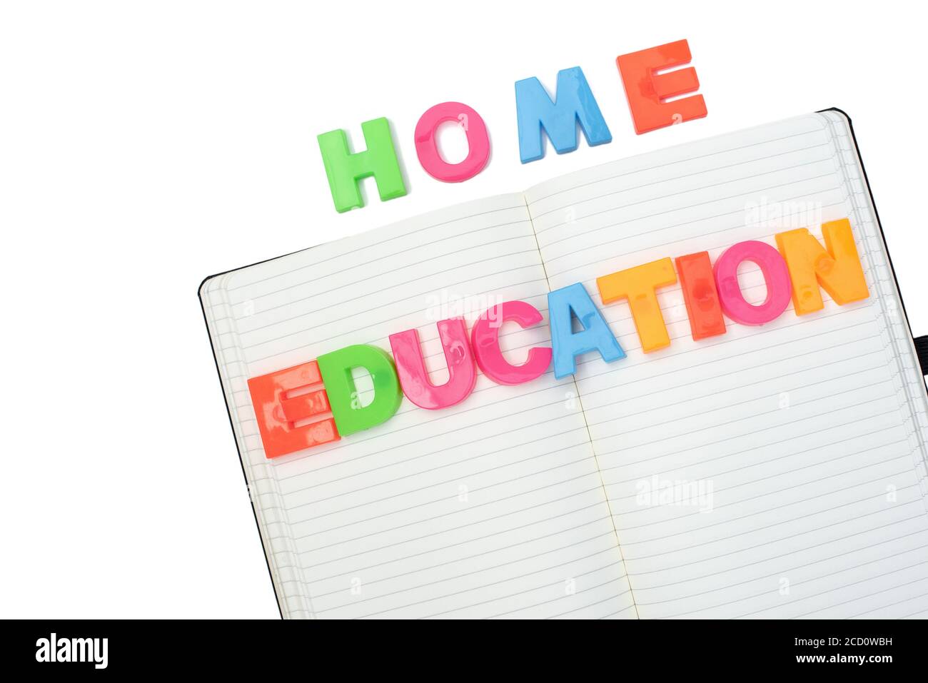 Colored plastic letters of the English alphabet and a notebook on a ...