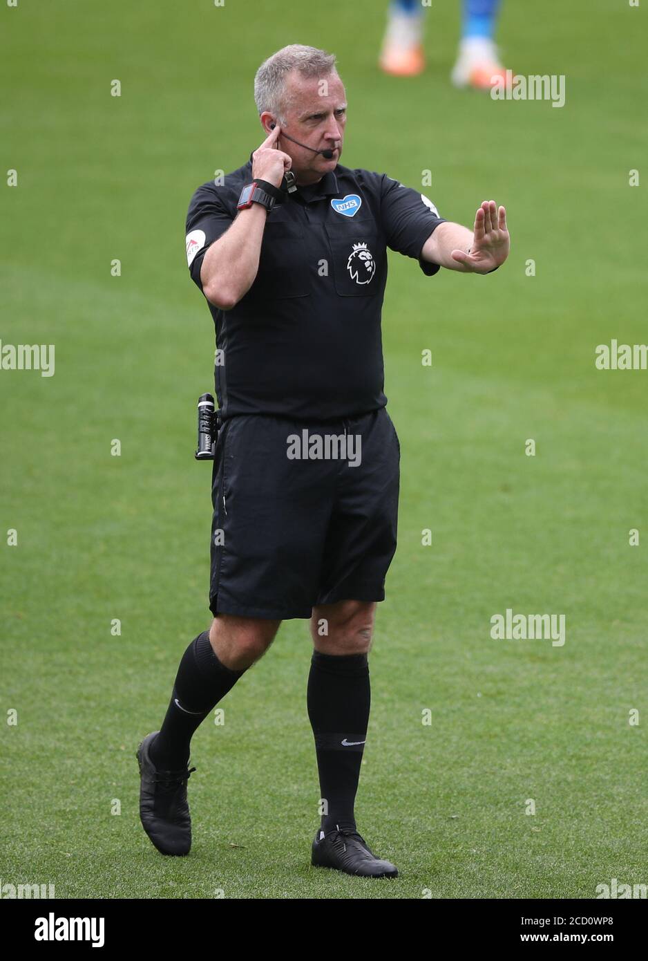 Referee Jonathan Moss holds the game up as he listens to VAR control at ...