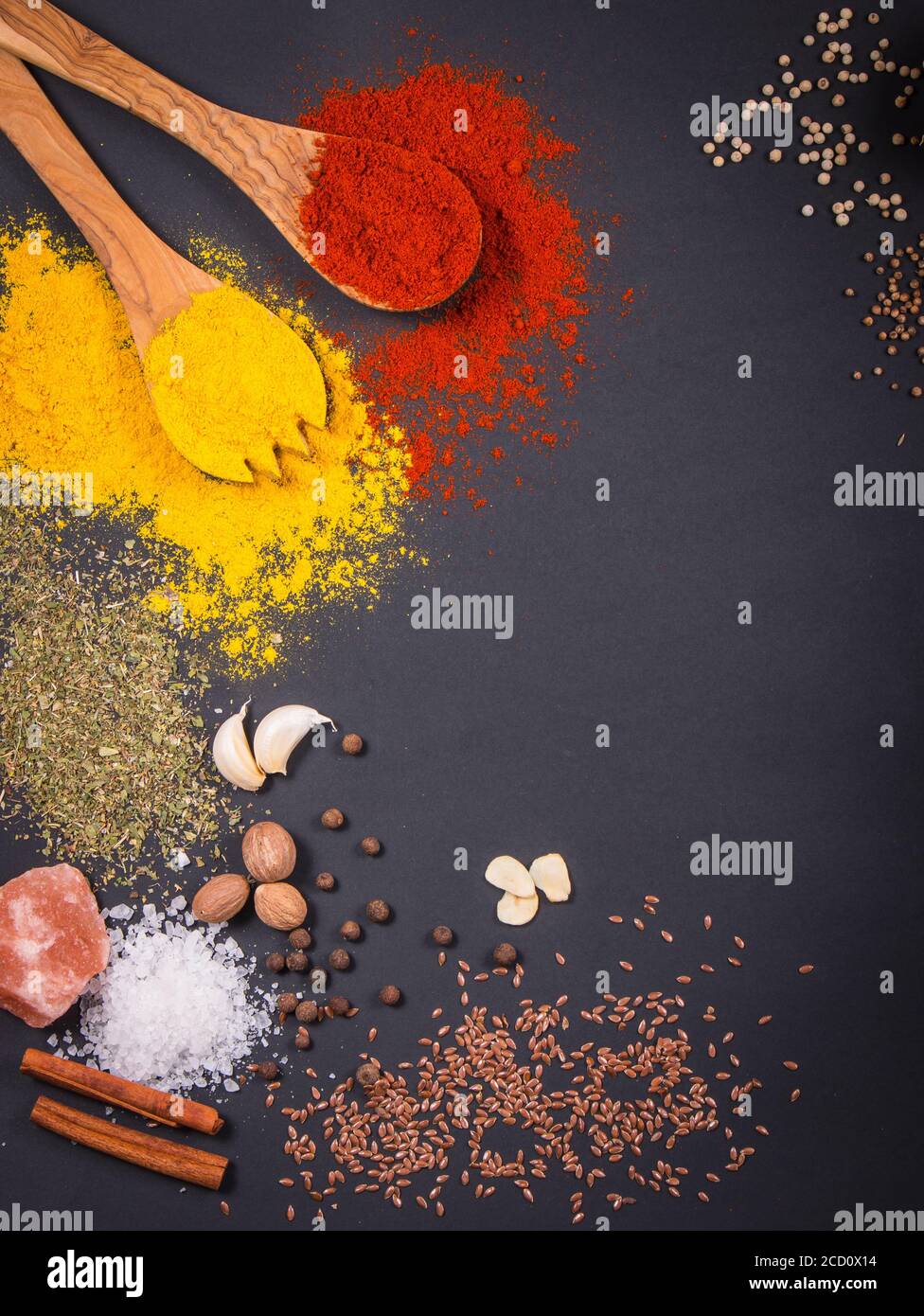 Natural spices and herbs scattered on dark background. Natural and bio ...
