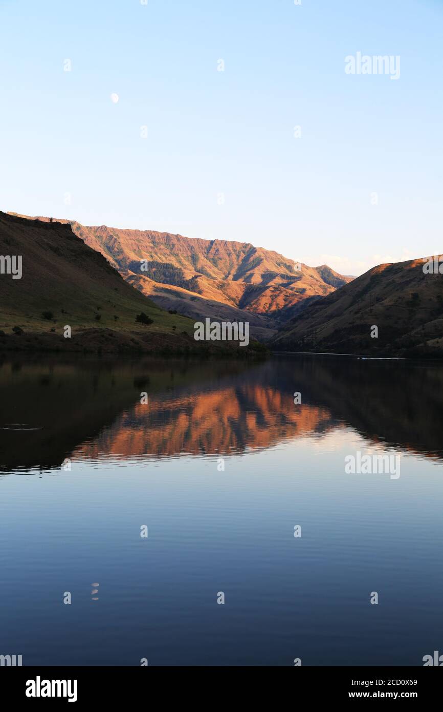 moon rising at dusk over oxbow dam in idaho Stock Photo - Alamy
