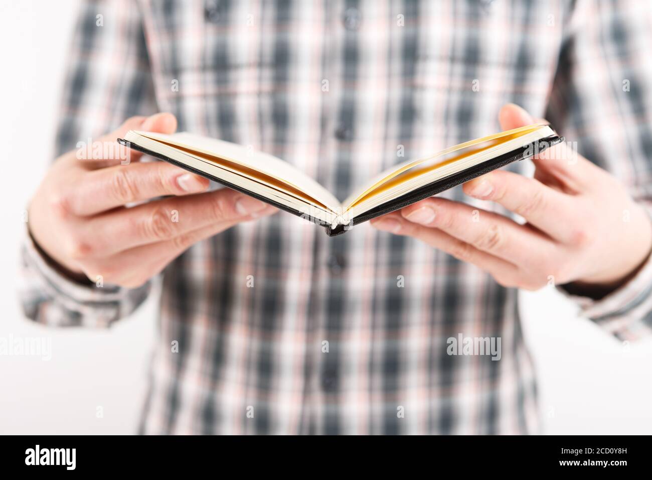 Hands holding up an open book to face hi-res stock photography and ...
