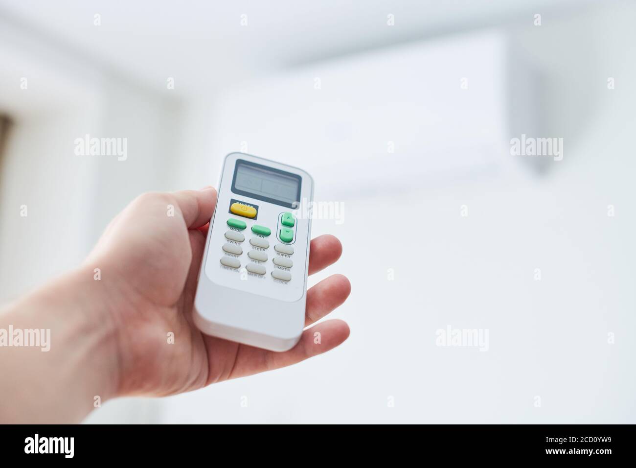 Air condition remote control. Hand with room conditioner remote control ...