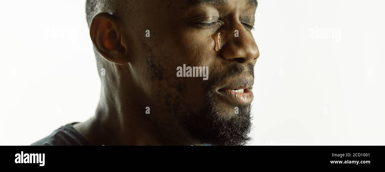 Crying. African-american young man's close up shot on studio background ...
