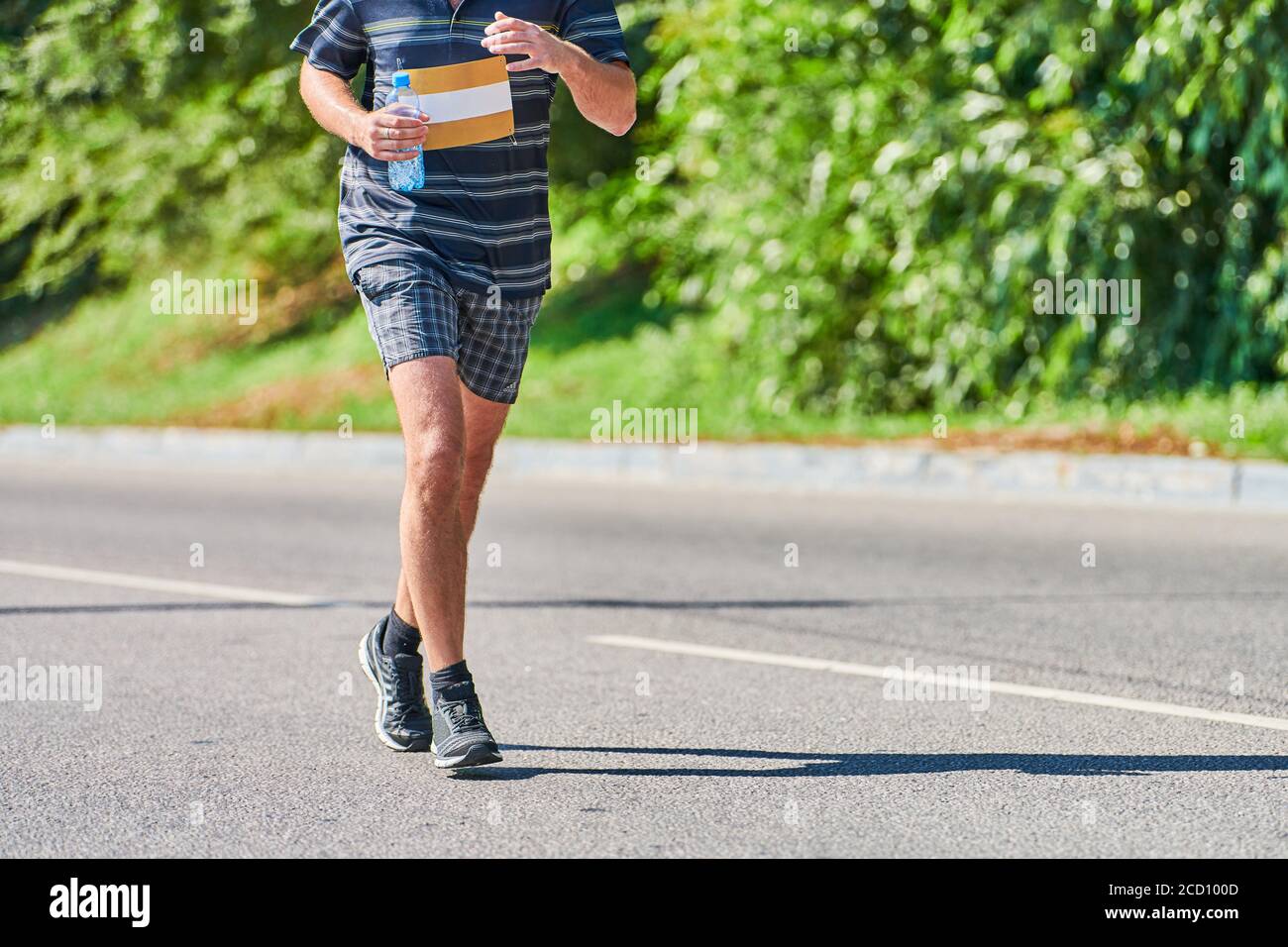 Running man. Athletic man jogging in sportswear on city road. Healthy ...