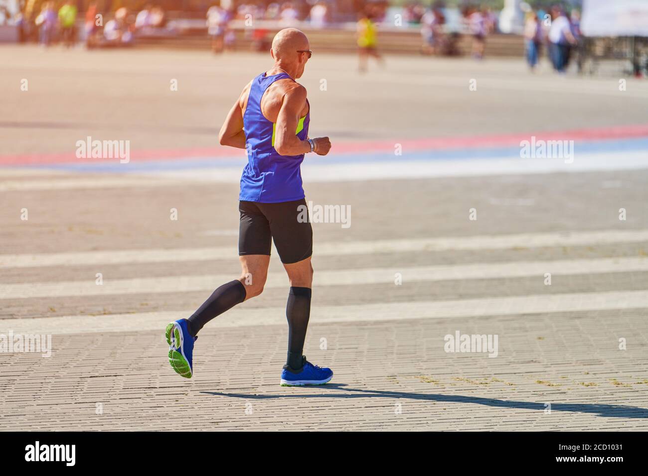 Running man. Athletic man jogging in sportswear on city road. Healthy lifestyle, fitness sport ...