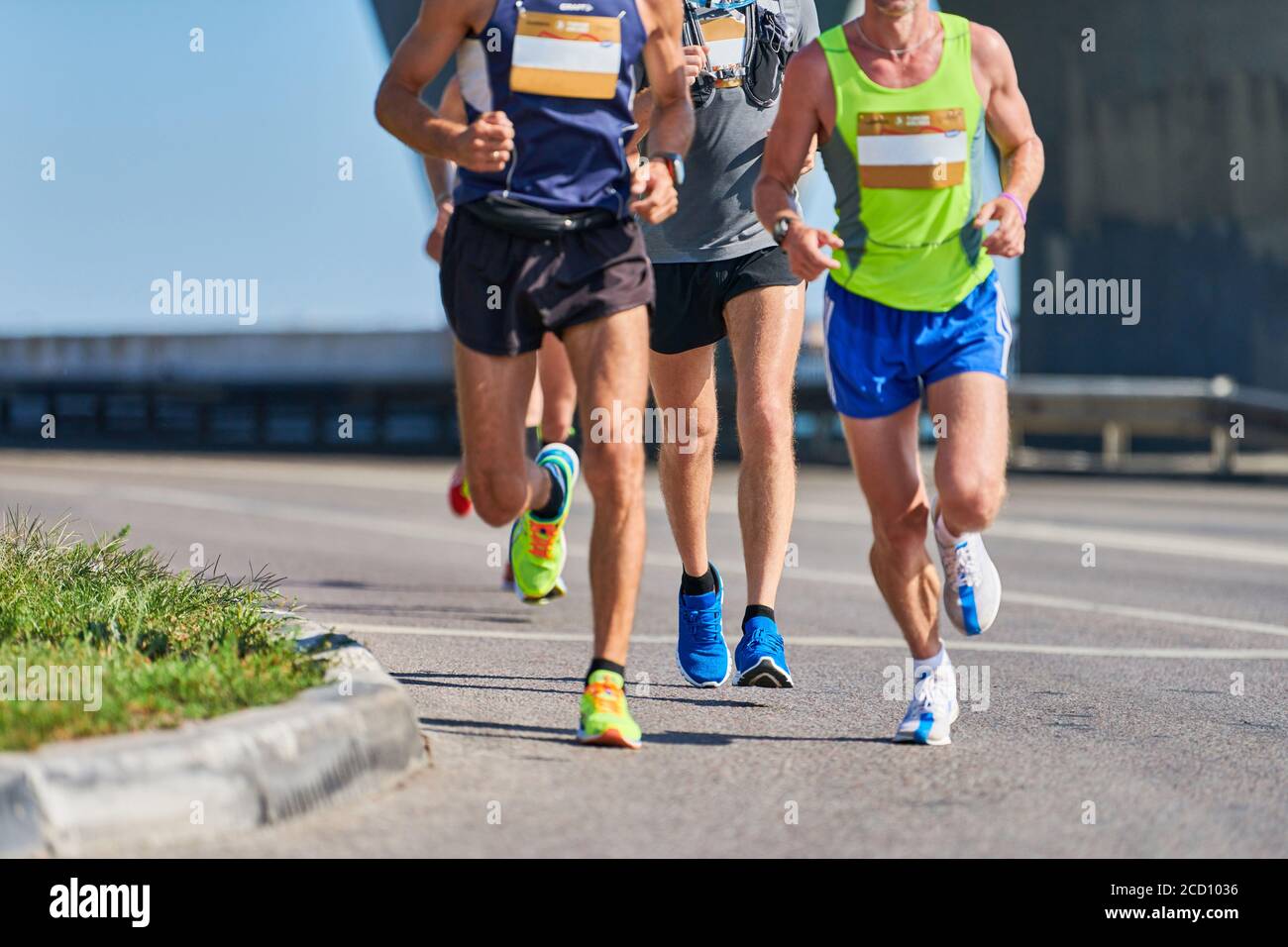Marathon runners on city road. Running competition. Street sprinting ...