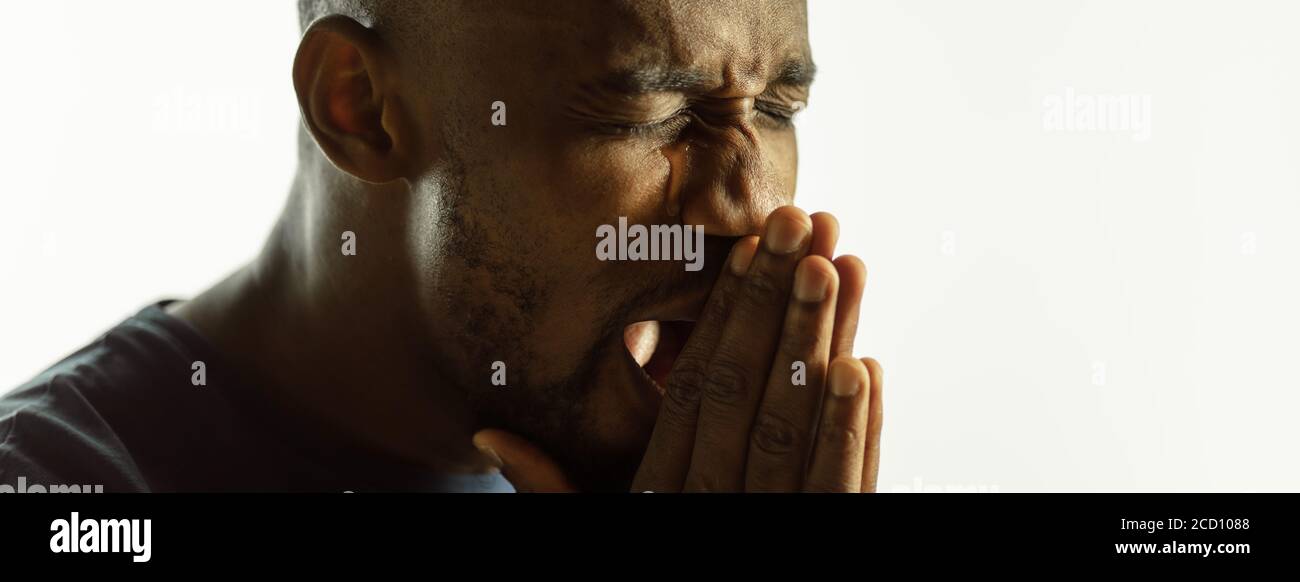Crying. African-american young man's close up shot on studio background ...
