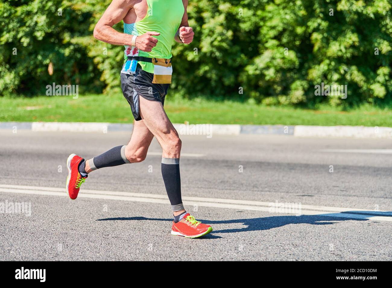 Running man. Athletic man jogging in sportswear on city road. Healthy ...