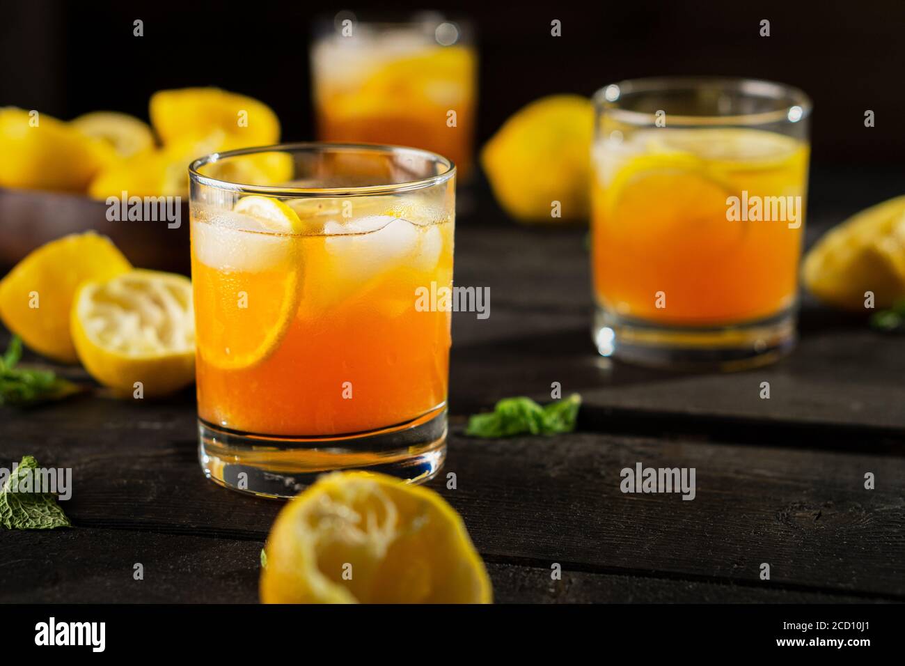 Homemade lemon iced tea glass on dark background. A refreshing summer ...