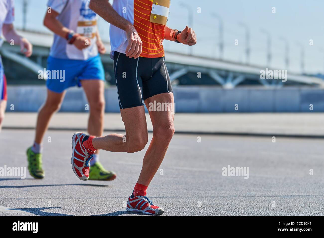 Marathon runners on city road. Running competition. Street sprinting ...