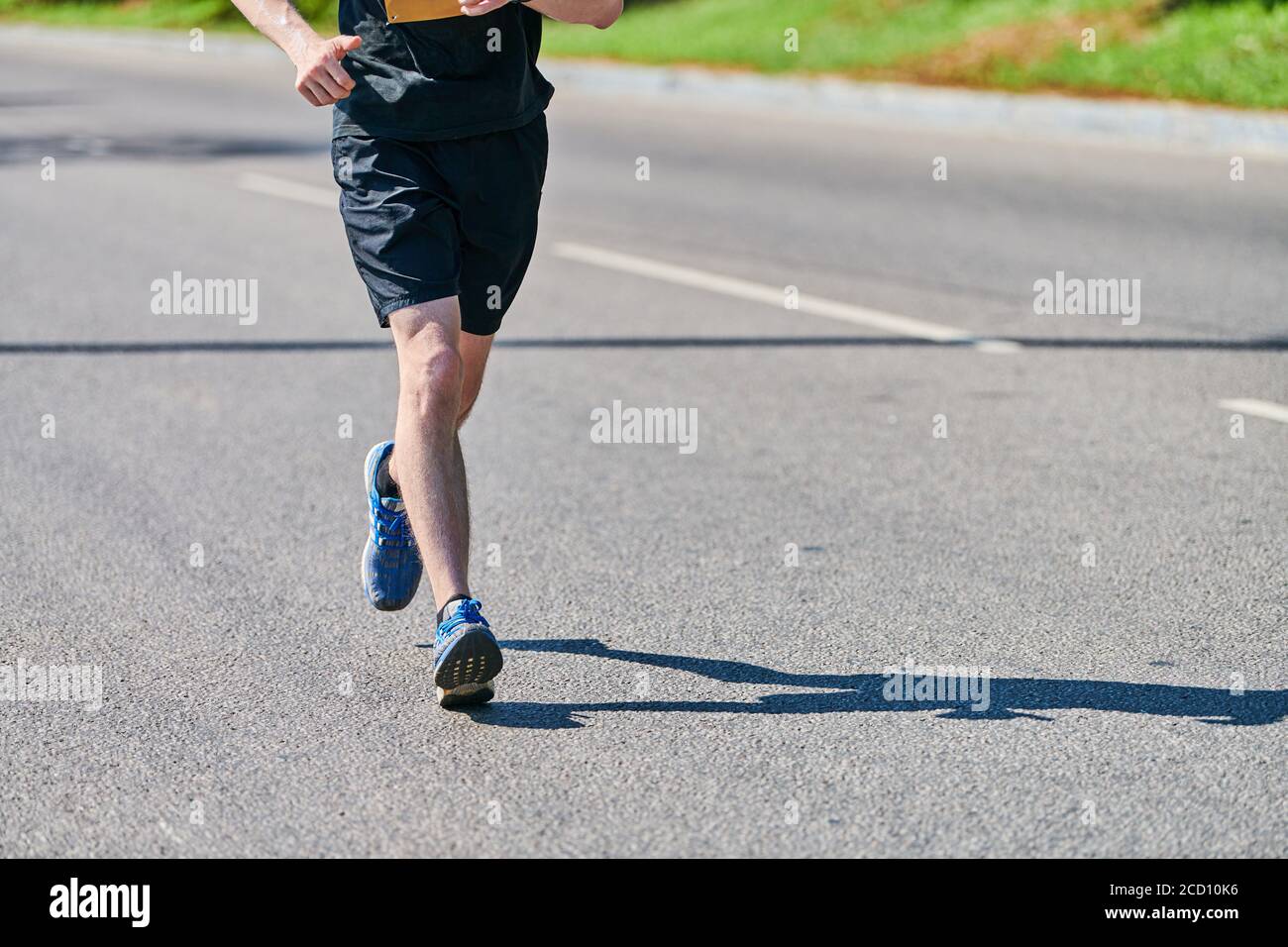 Running man. Athletic man jogging in sportswear on city road. Healthy lifestyle, fitness sport ...