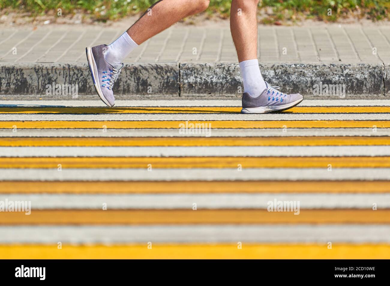 Man running crosswalk, copy space. Athletic man jogging in sportswear ...