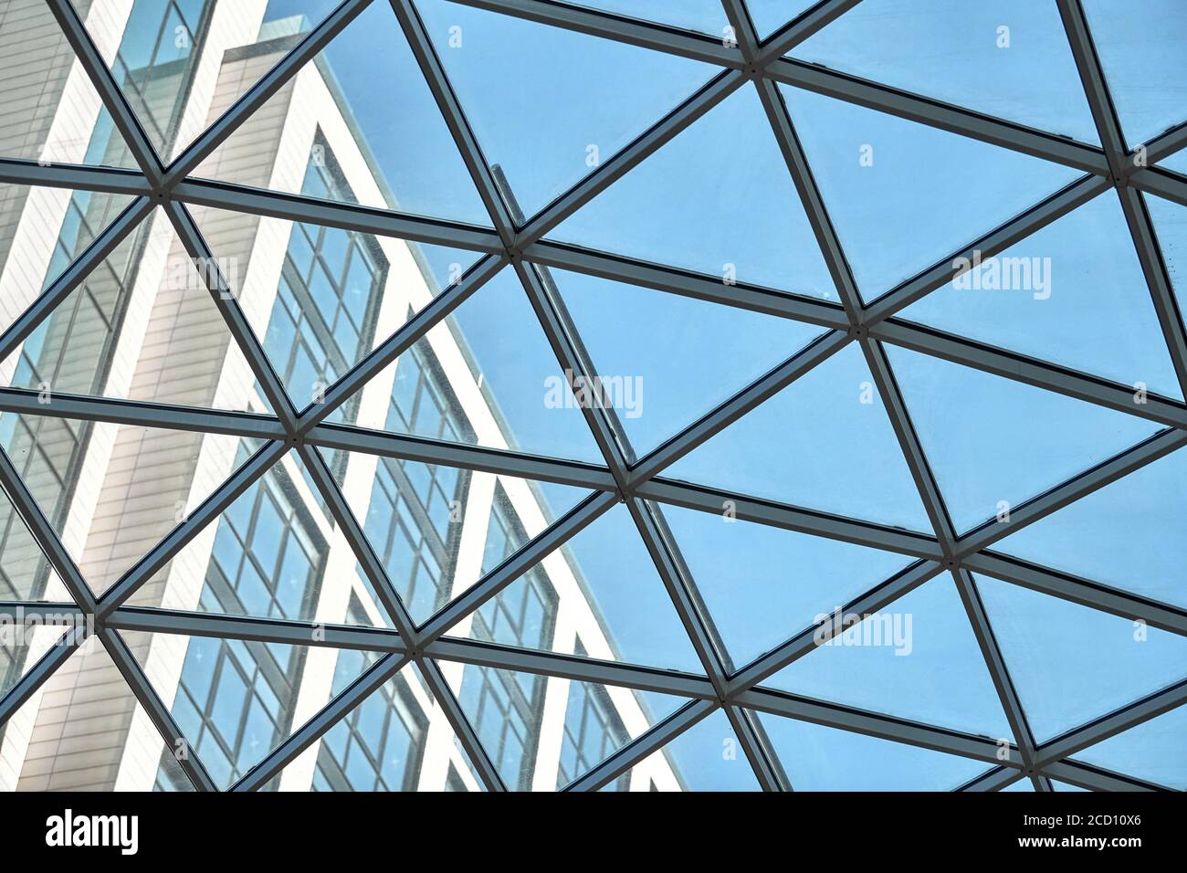 Transparent ceiling in business center. Glass triangle windows. Mesh ...