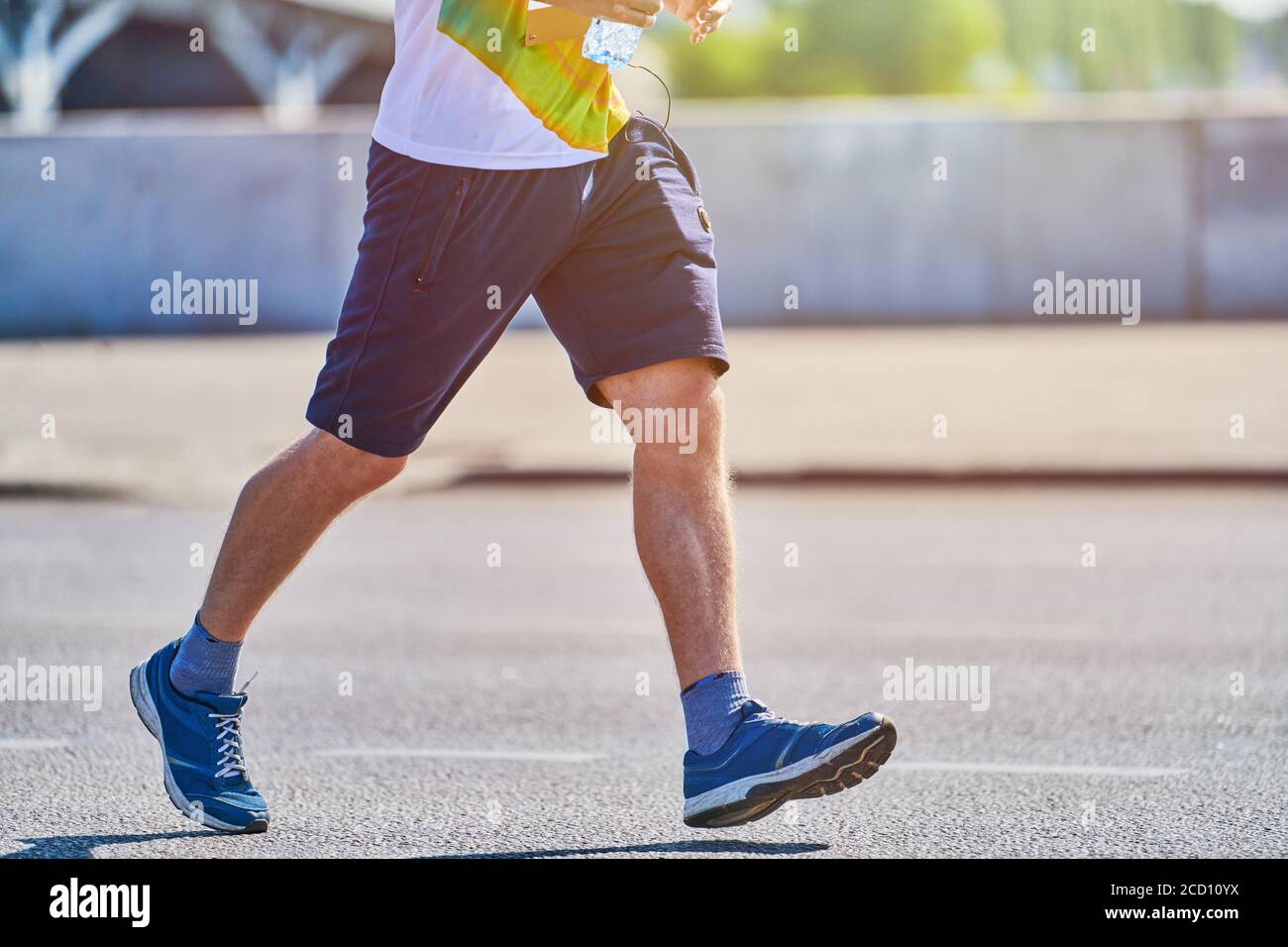 Running man. Athletic man jogging in sportswear on city road. Healthy ...