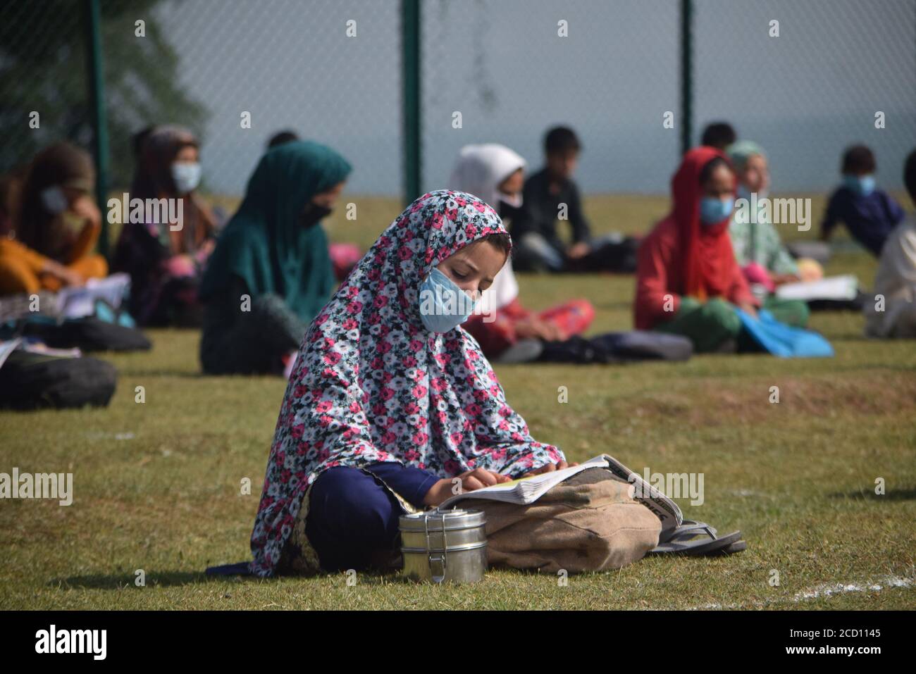 Students attending their open air classes at Doodhpathri in Budgam ...
