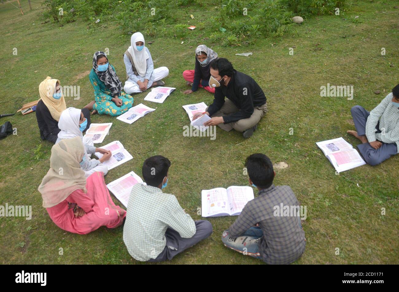 Students attending their open air classes at Doodhpathri in Budgam ...