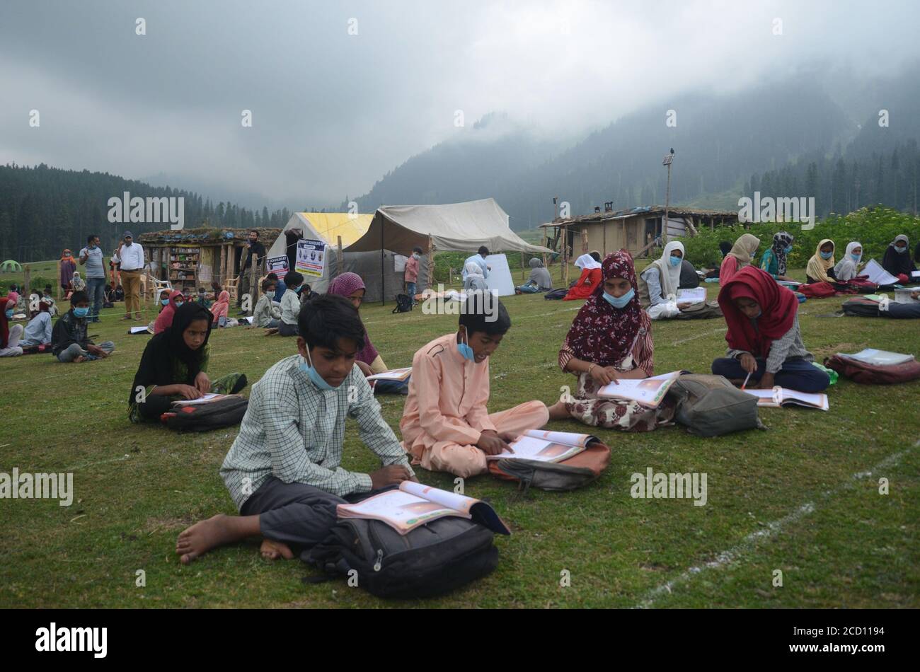 Students attending their open air classes at Doodhpathri in Budgam ...