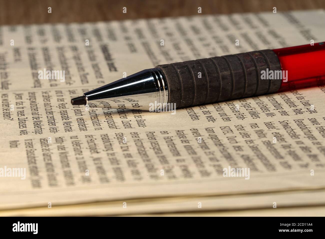 Closeup of a ballpoint pen lying on a newspaper Stock Photo - Alamy
