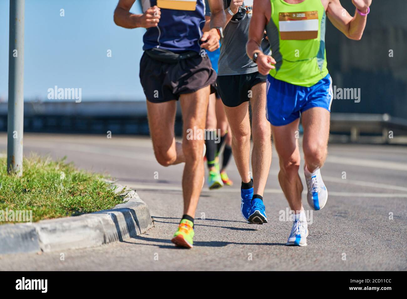 Marathon runners on city road. Running competition. Street sprinting ...