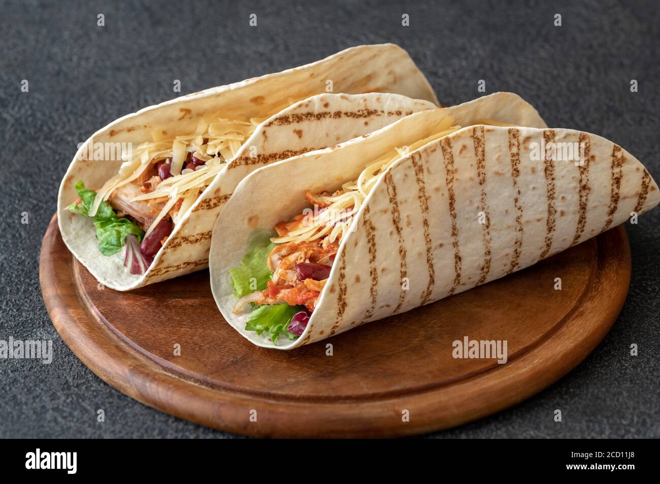 Tacos - traditional Mexican dish on wooden board Stock Photo - Alamy