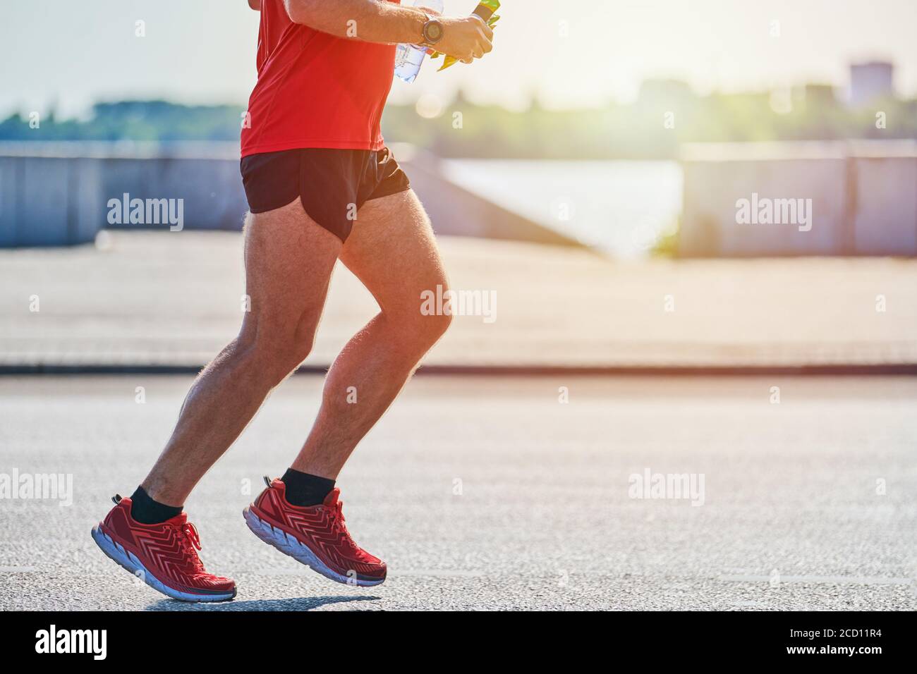 Running man. Athletic man jogging in sportswear on city road. Healthy lifestyle, fitness sport ...
