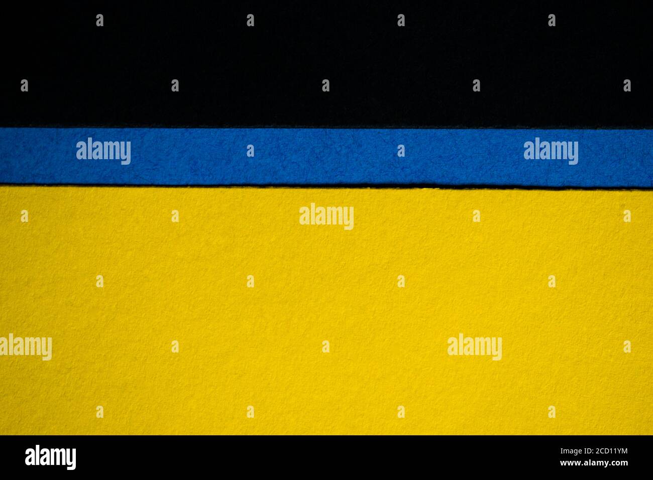 Yellow and black colored paper background divided horizontally with ...