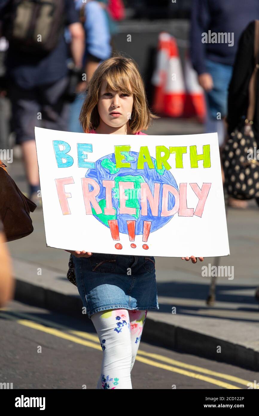Portrait of a young girl holding up a protest sign during the Climate ...