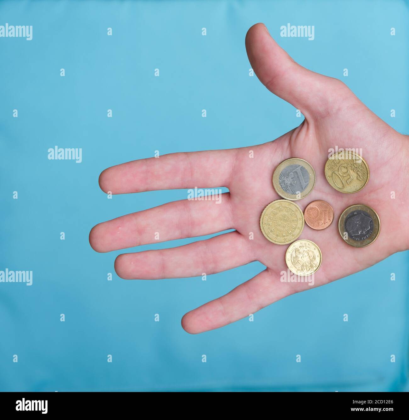 Euro coins held in palm of hand Stock Photo - Alamy