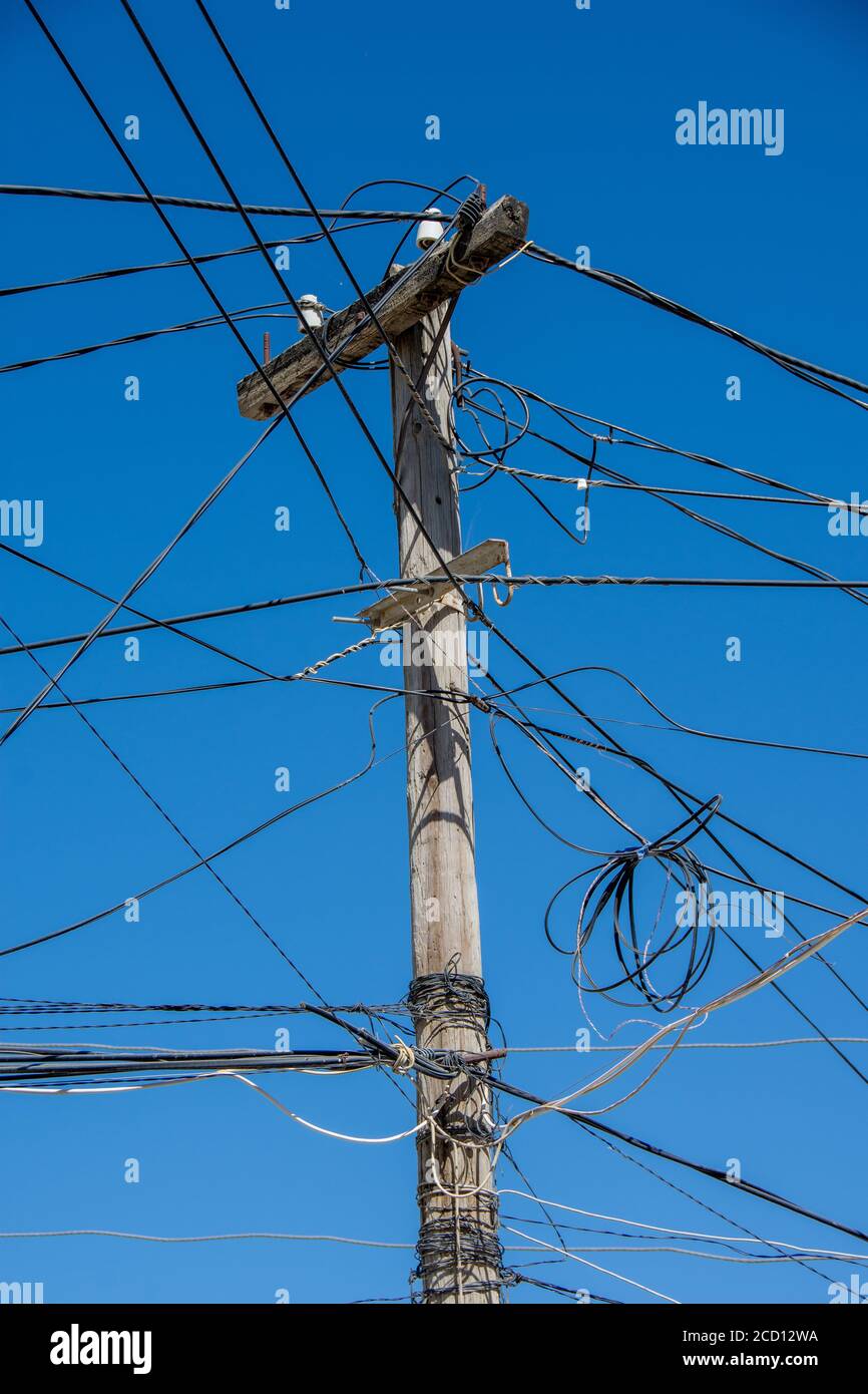Electric pole with cables tangled in an anarchic manner. Concept of ...