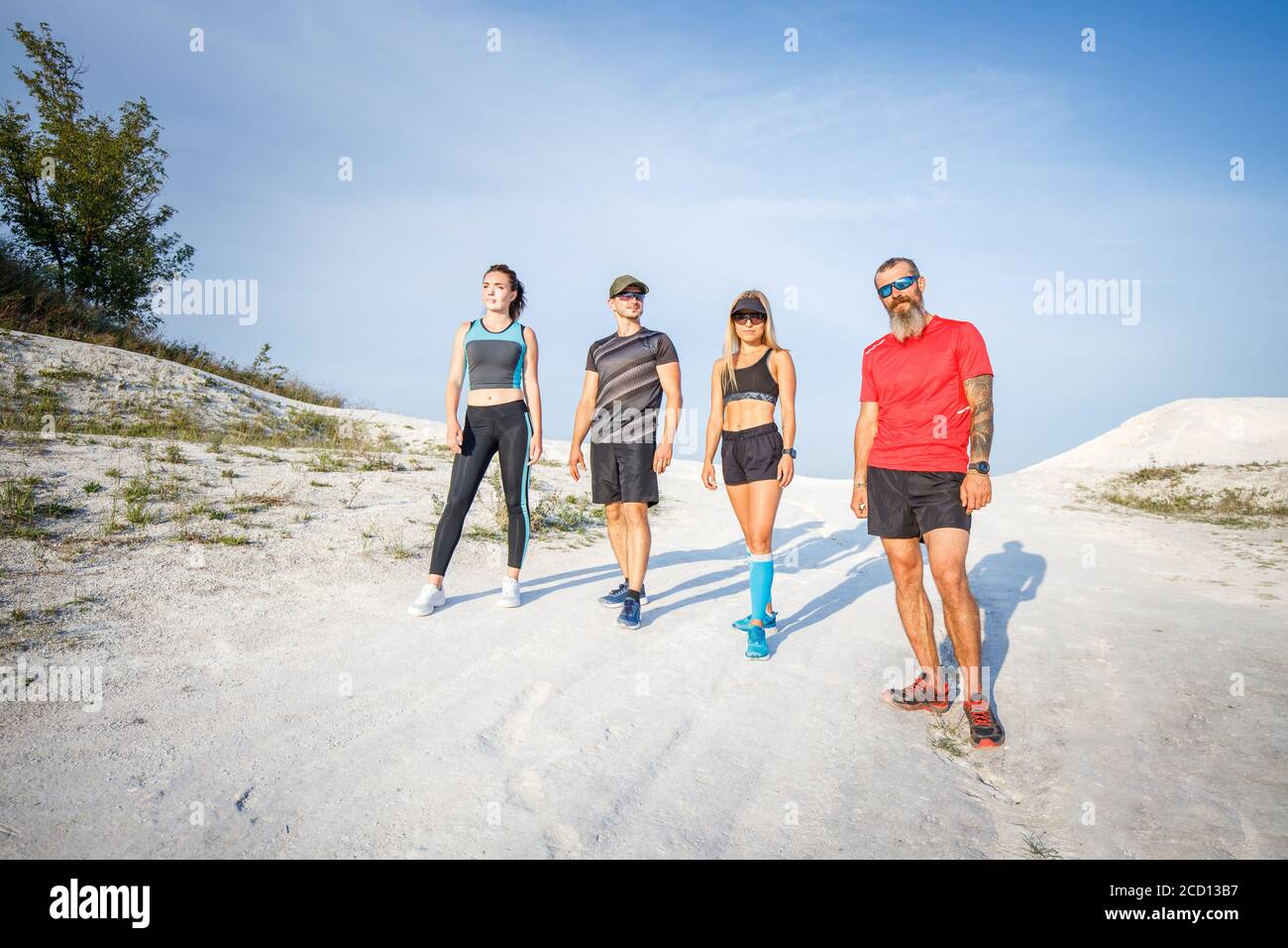 Group of runners standing outdoors before trail running training. Low ...