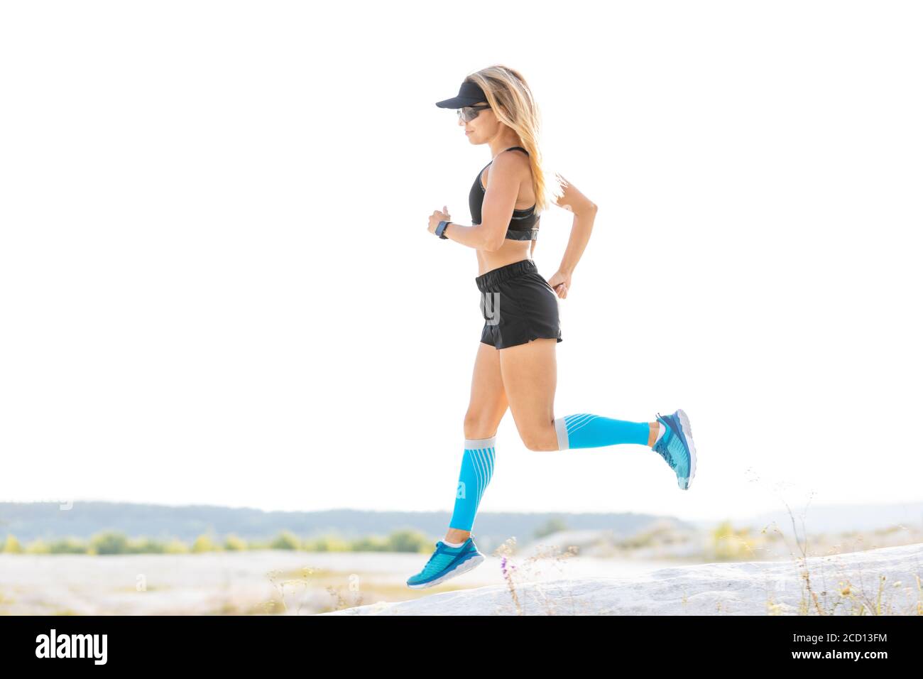 Young fitness runner woman jumping on trail path. Slim girl jogging ...